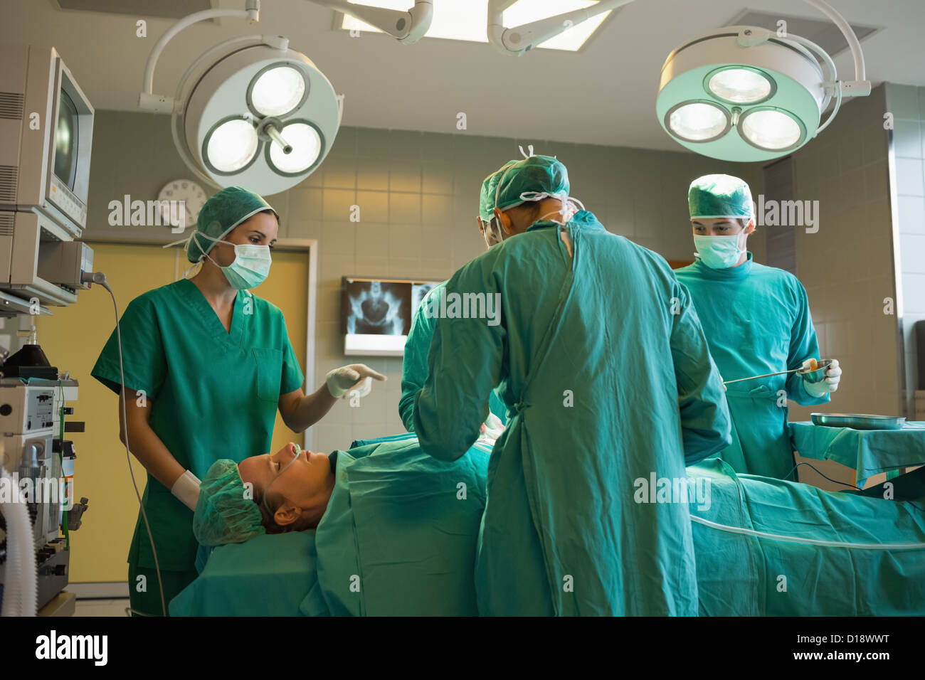 Group of surgeons working on a female patient Stock Photo - Alamy
