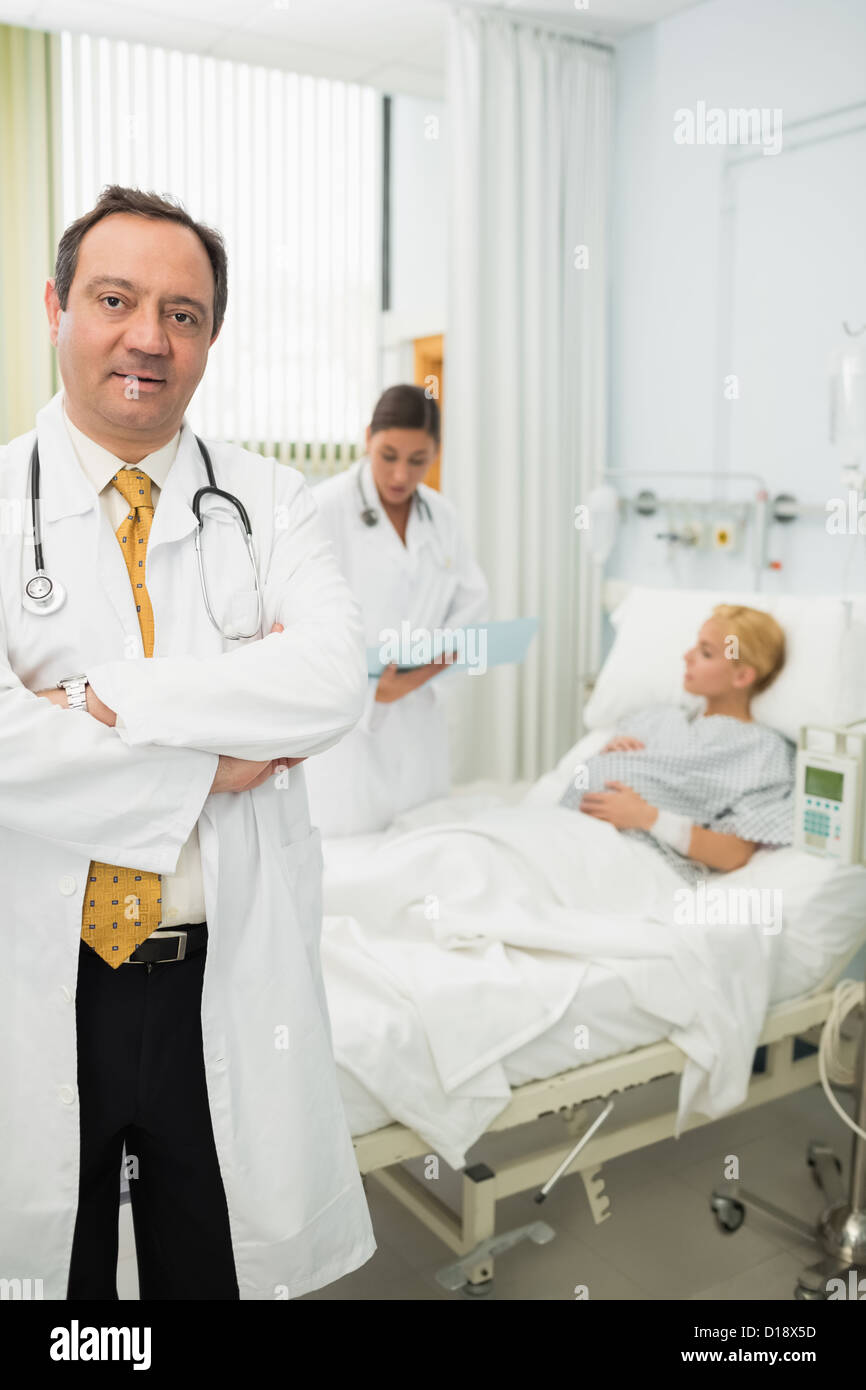Doctor folding his arms Stock Photo - Alamy