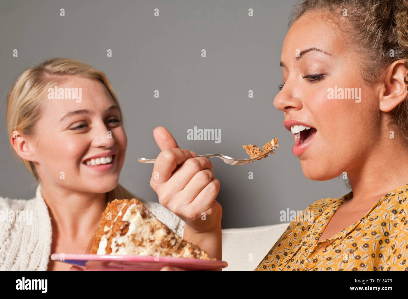 Friends eating cake Stock Photo - Alamy