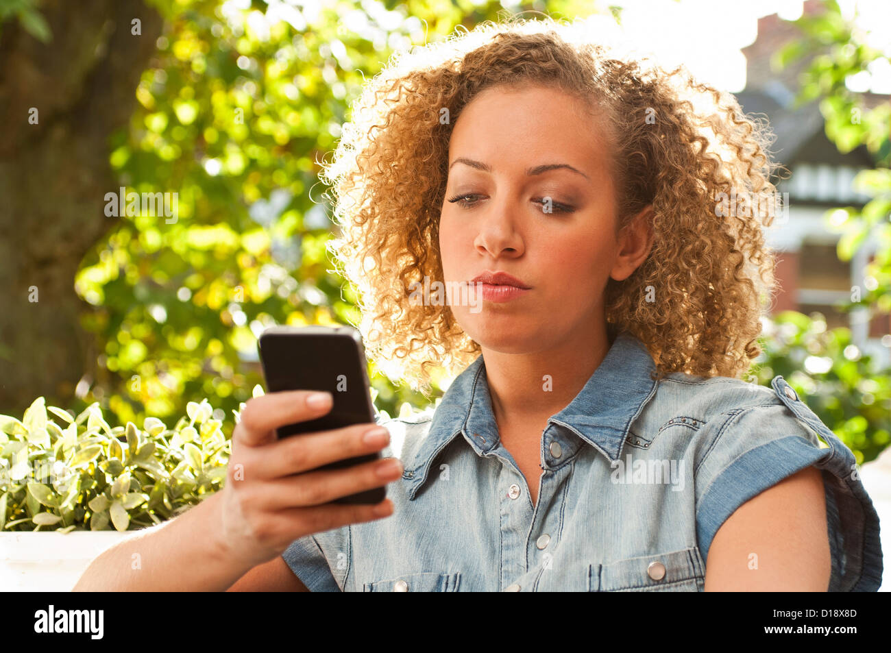 Woman holding cell phone Stock Photo - Alamy