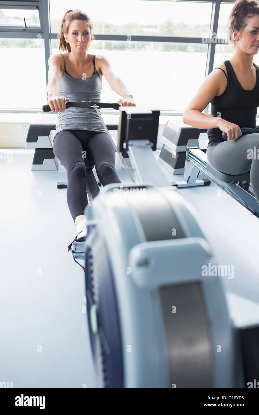 Woman using rowing machine Stock Photo - Alamy