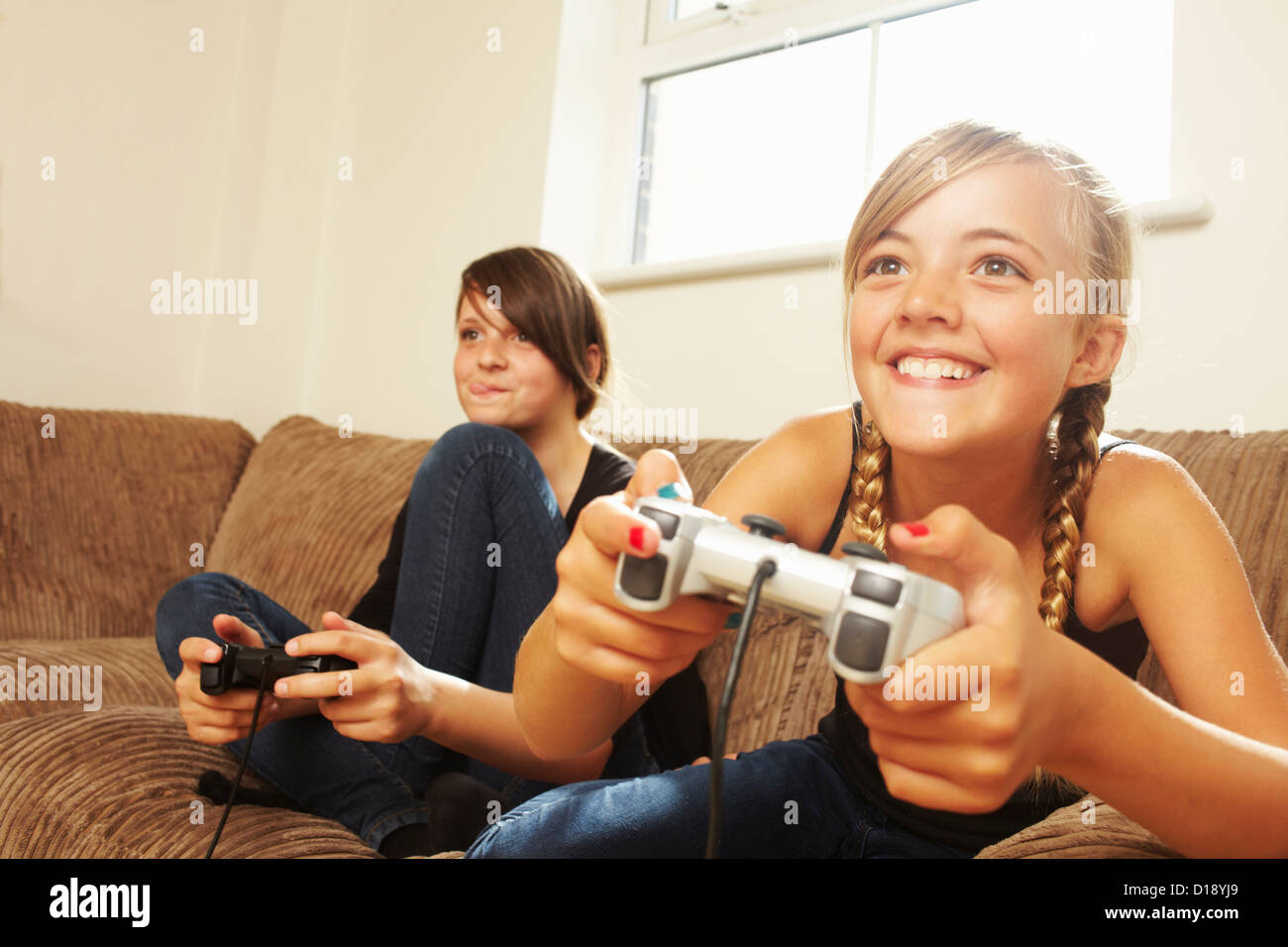 Two girls playing video game Stock Photo - Alamy