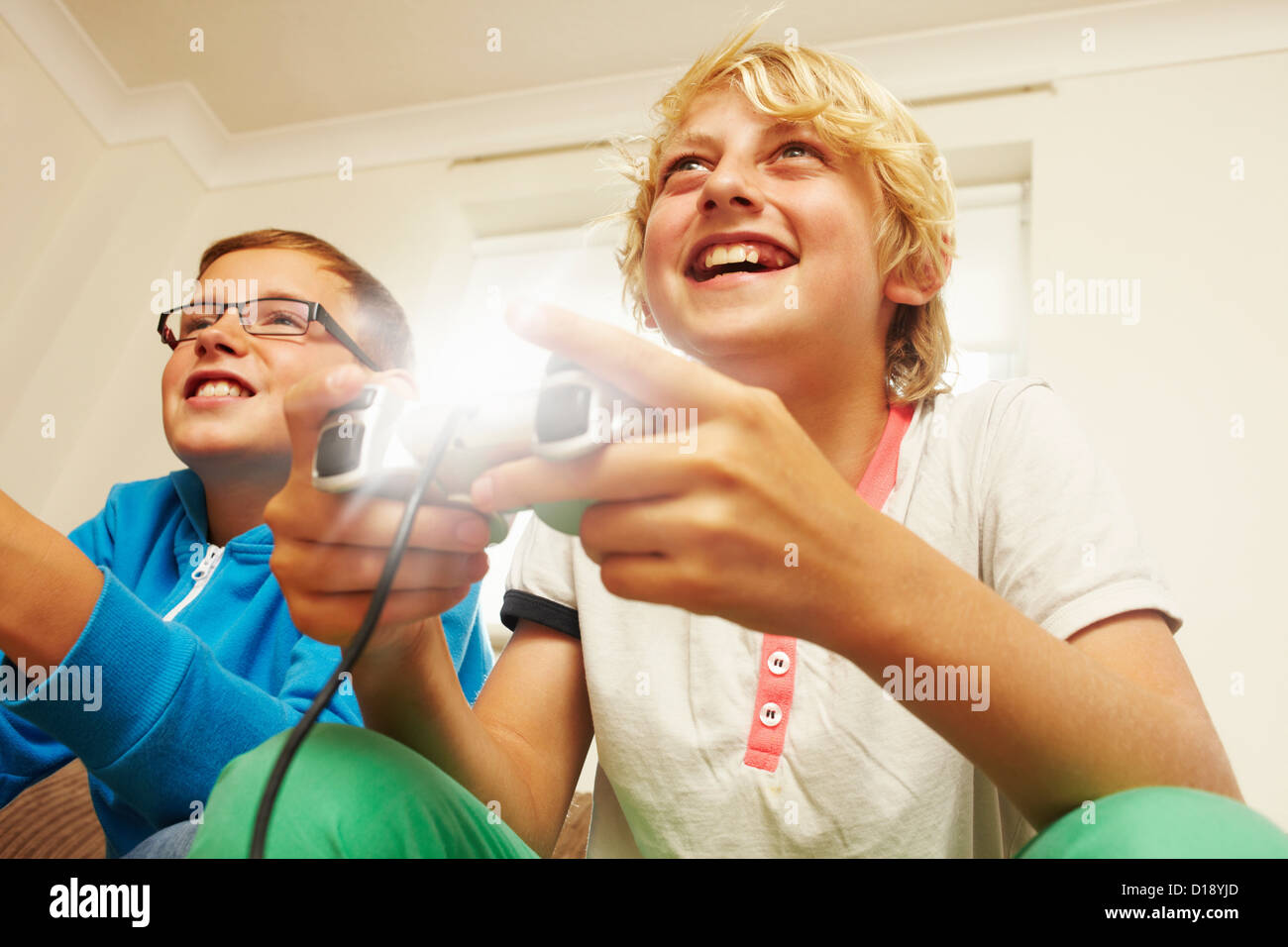 Two boys playing video game Stock Photo - Alamy