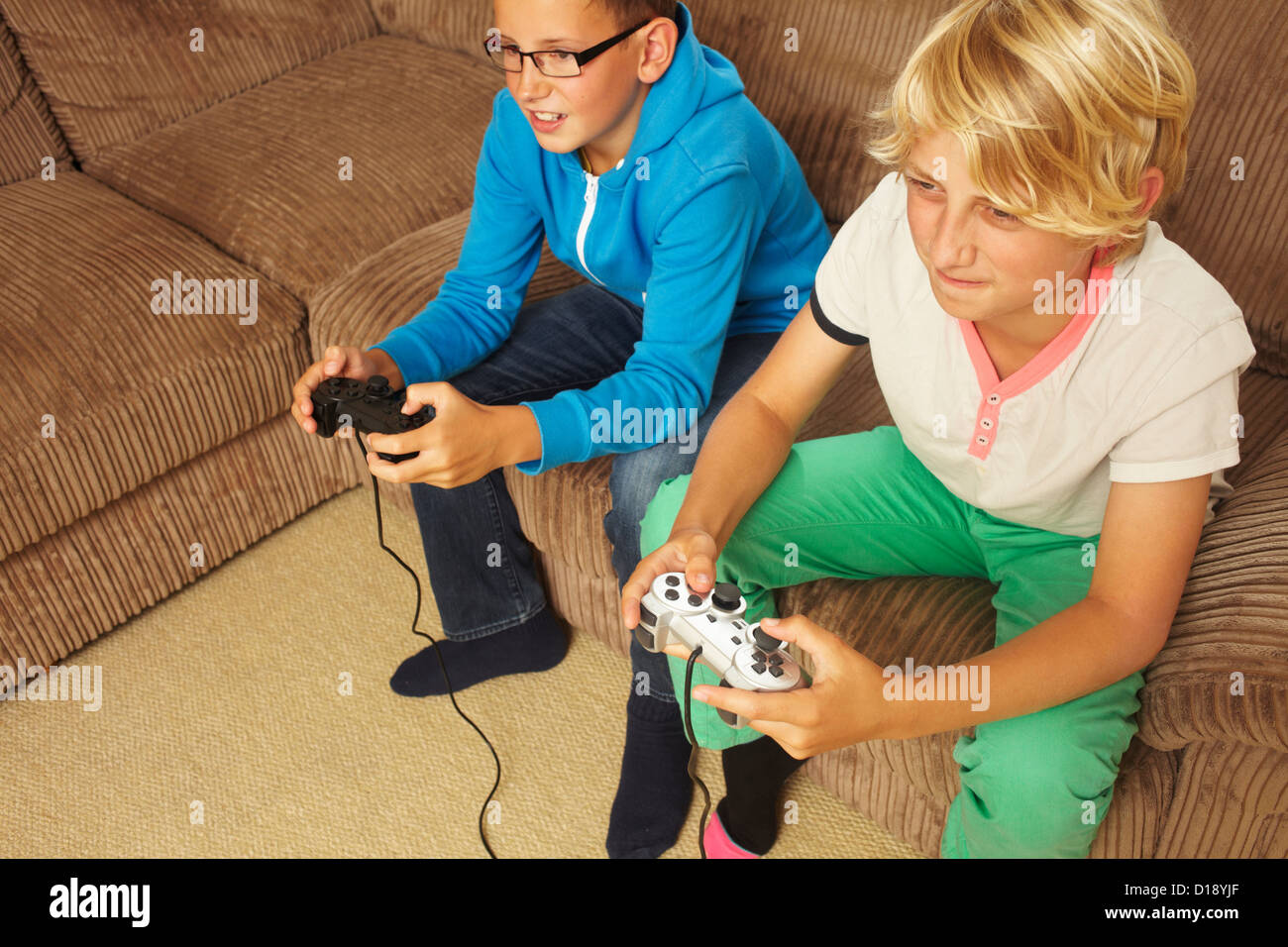 Two boys playing video game Stock Photo - Alamy
