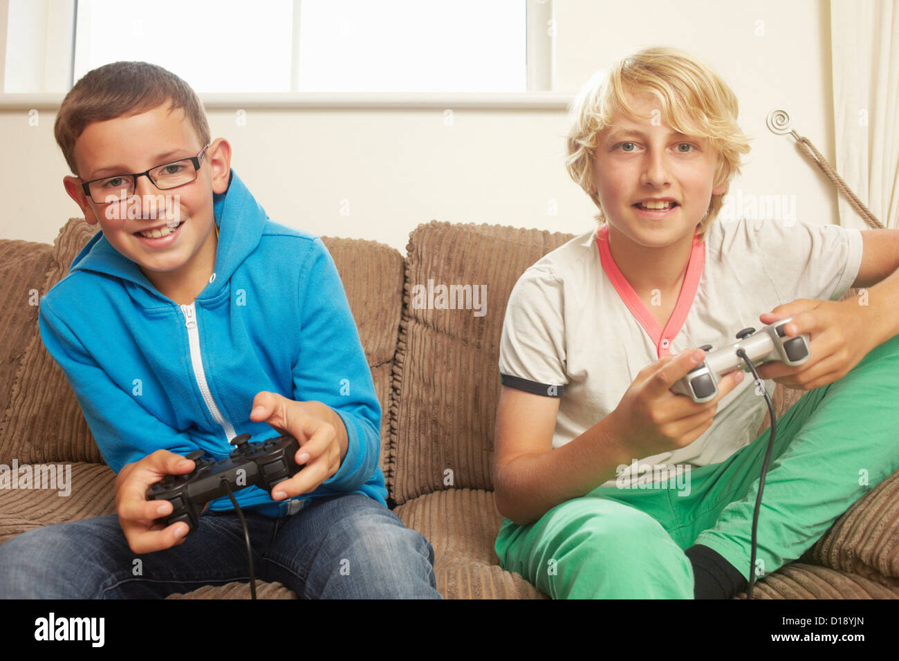 Two boys playing video game Stock Photo - Alamy