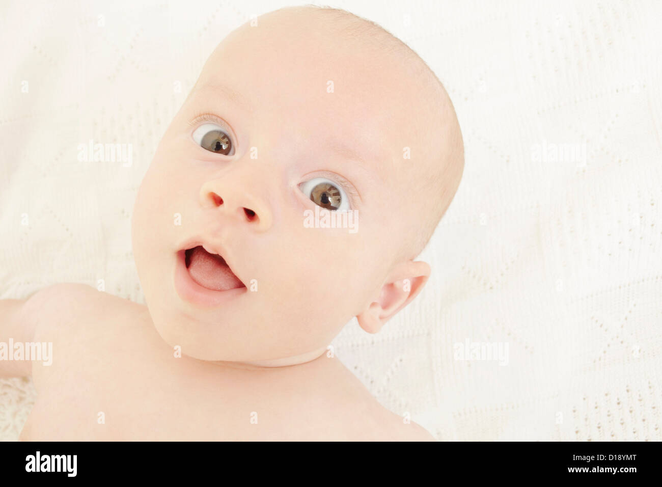 Baby girl staring at camera Stock Photo - Alamy