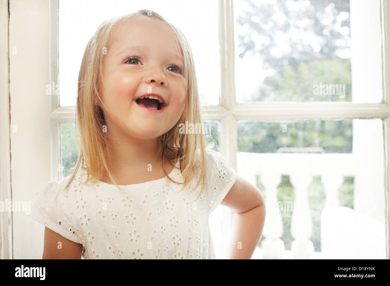 Happy little girl talking Stock Photo - Alamy