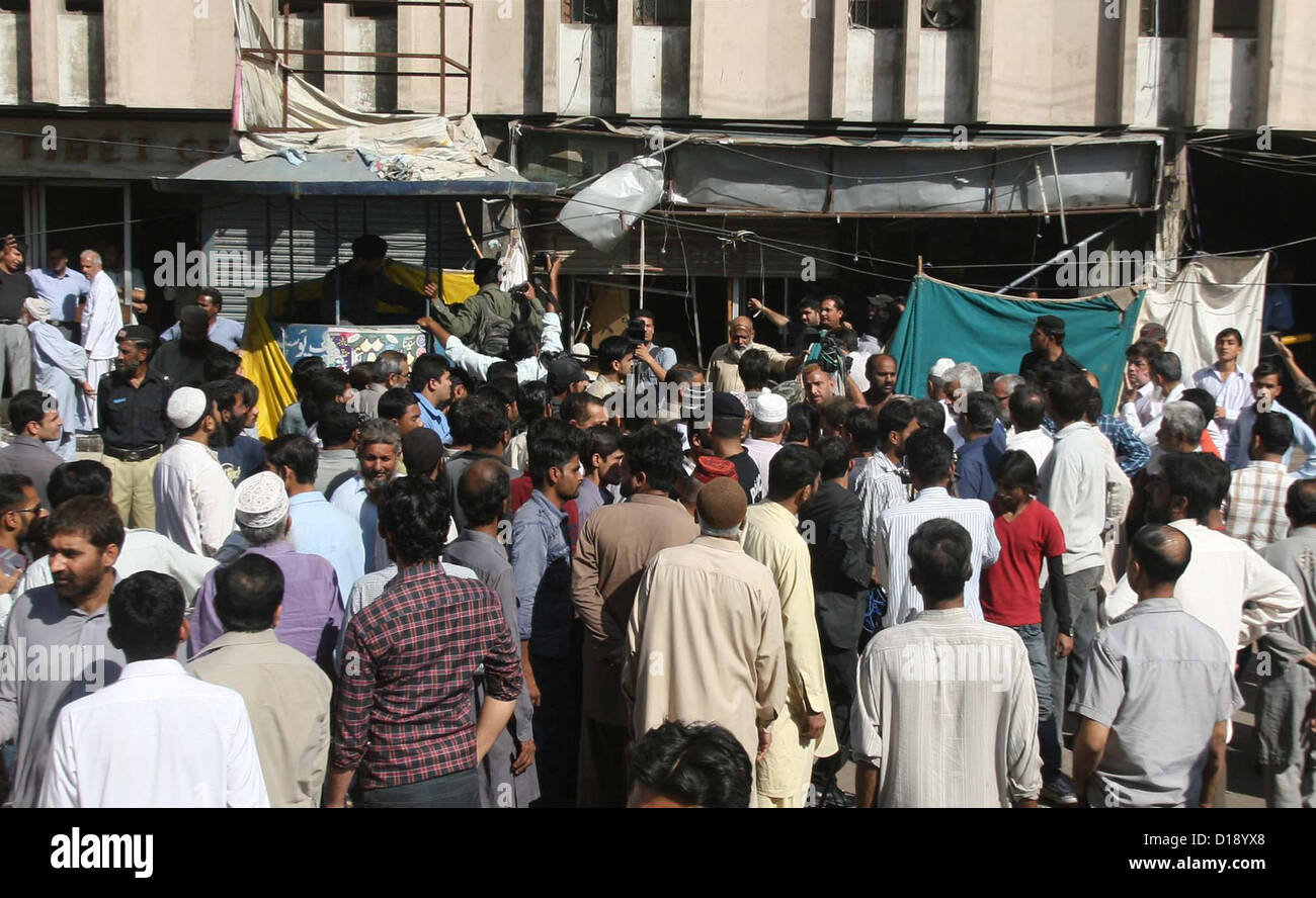 People gather near shop after hand grenade attack by extortion mafia ...