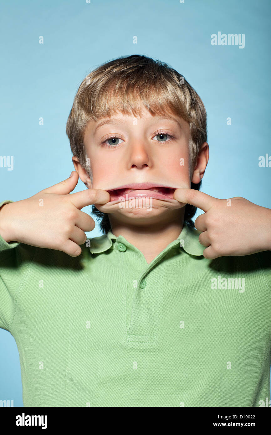 Boy pulling faces Stock Photo - Alamy