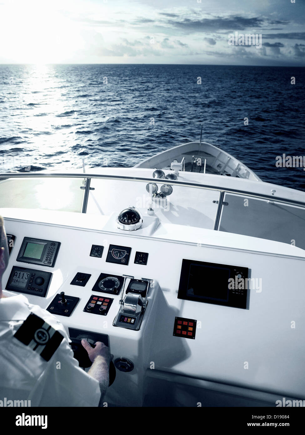 Captain at helm of large motor yacht Stock Photo - Alamy