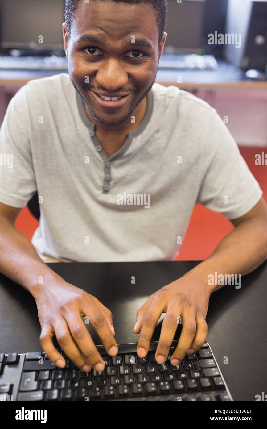 Smiling student typing Stock Photo - Alamy