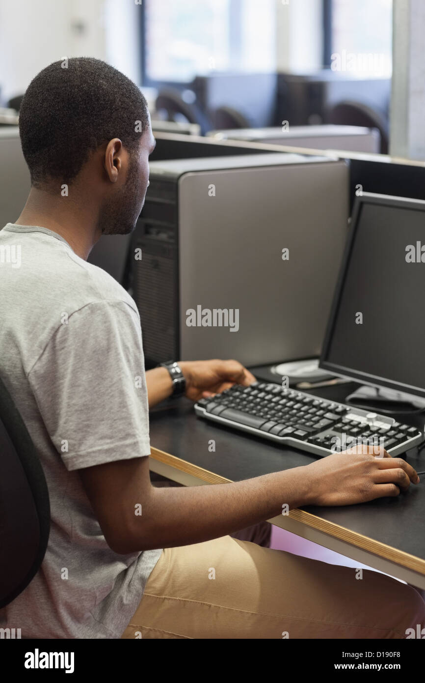 Man sitting at a computer Stock Photo - Alamy