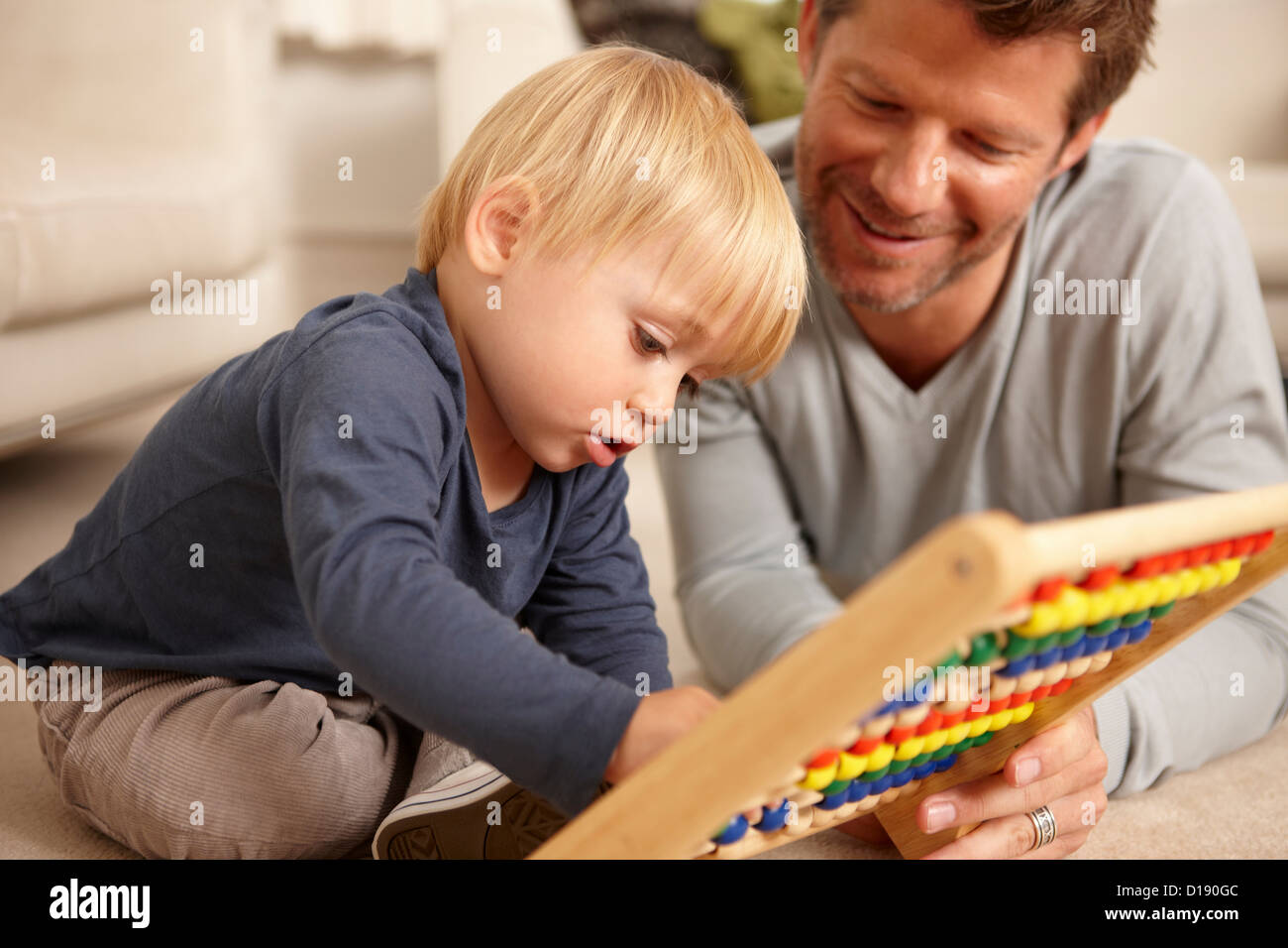 Father and son playing with abacus Stock Photo - Alamy