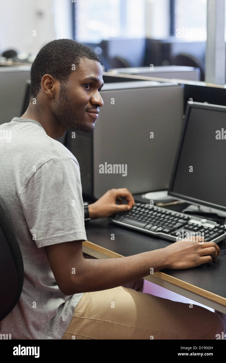 Man sitting at the computer looking up Stock Photo - Alamy