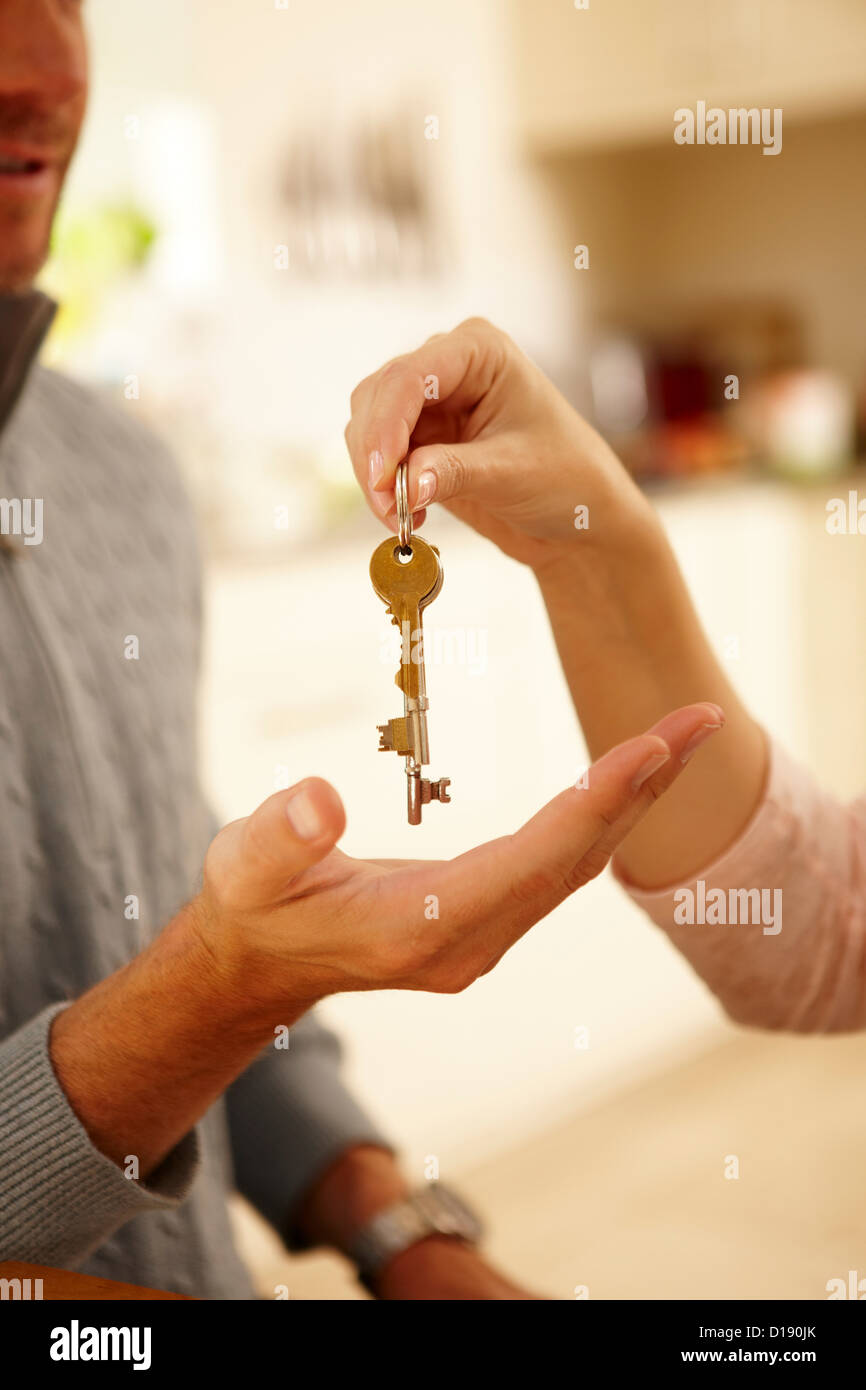 Woman giving man house key Stock Photo - Alamy