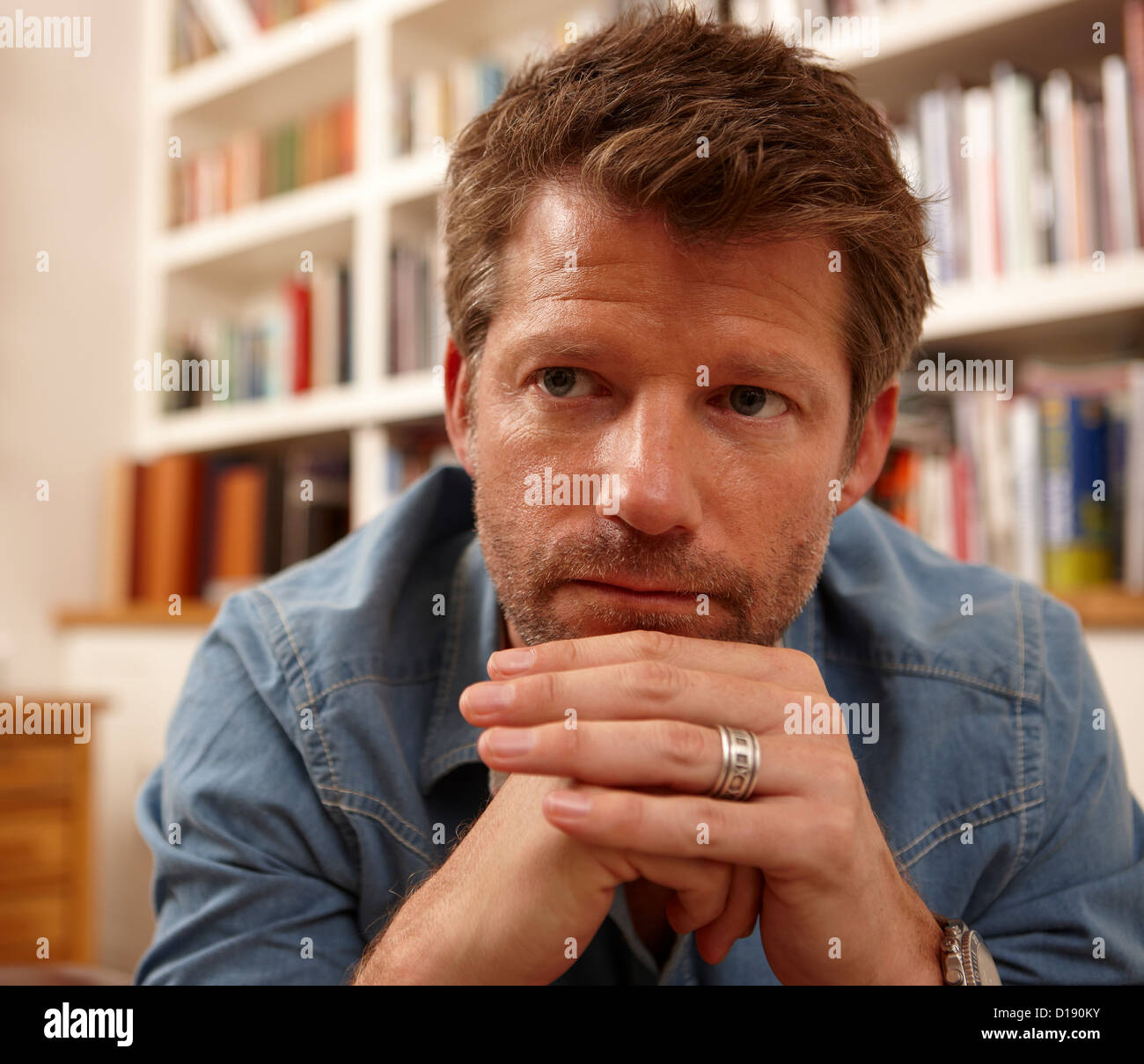 Portrait of man with hand on chin Stock Photo - Alamy