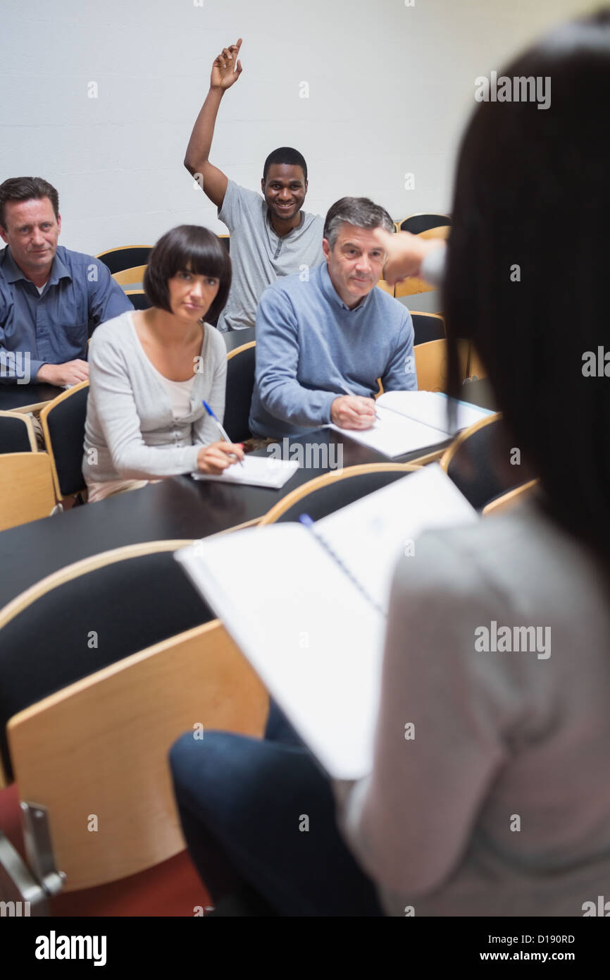 Smiling man asking question in lecture Stock Photo - Alamy
