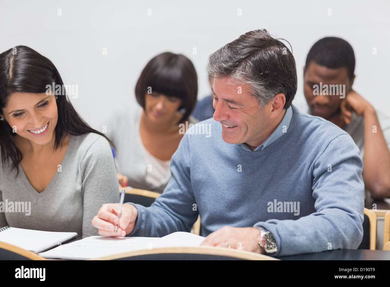 Man and woman talking during lecture Stock Photo - Alamy
