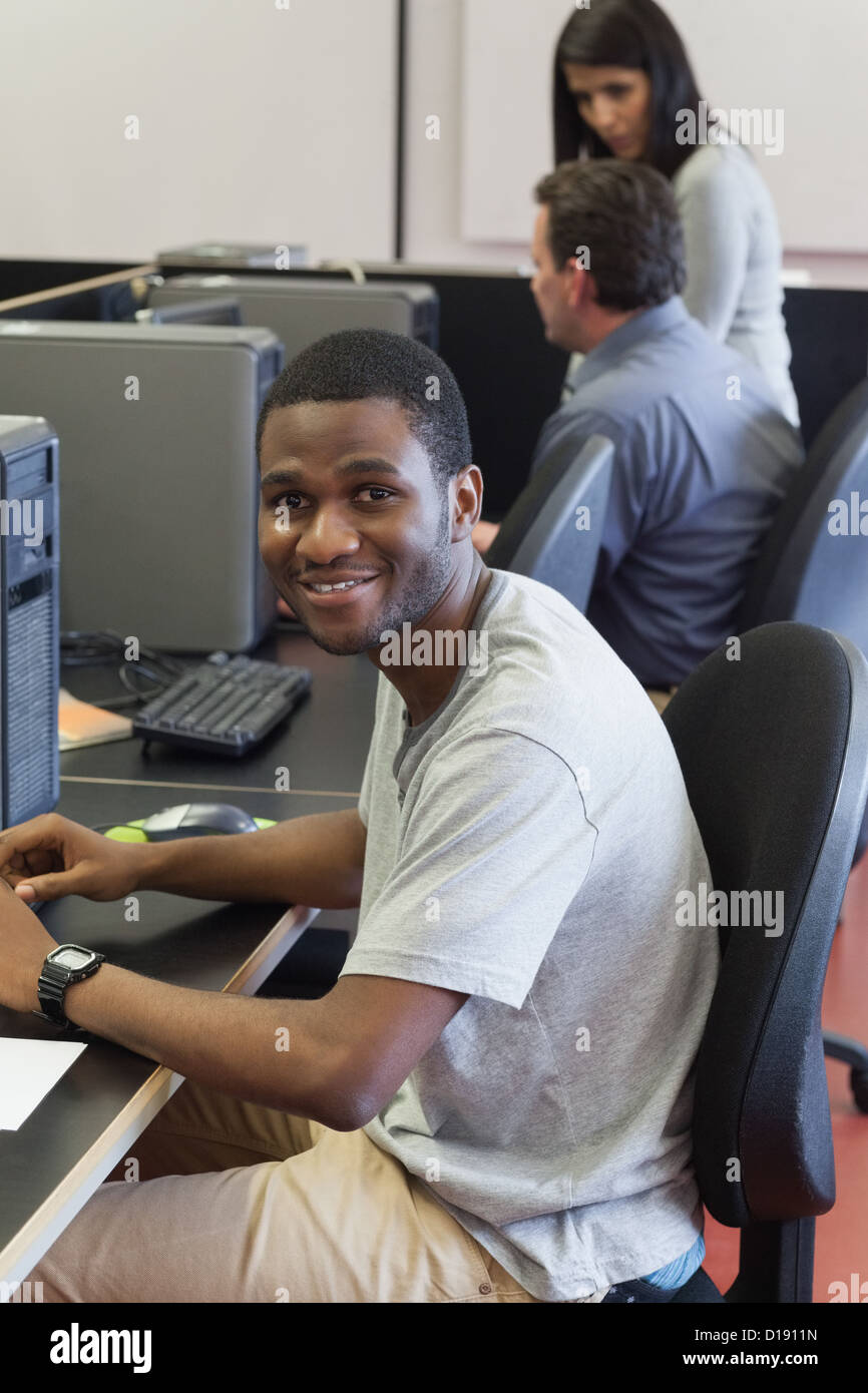 Happy student in computer class Stock Photo - Alamy