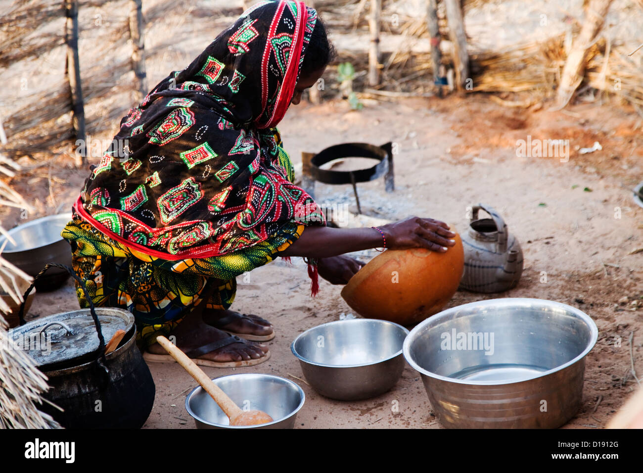 Wodaabe nomad woman cooking at the Wodaabe camp near Ingal, Niger ...
