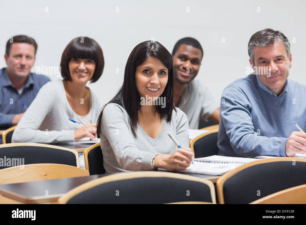 Smiling group in a lecture Stock Photo - Alamy