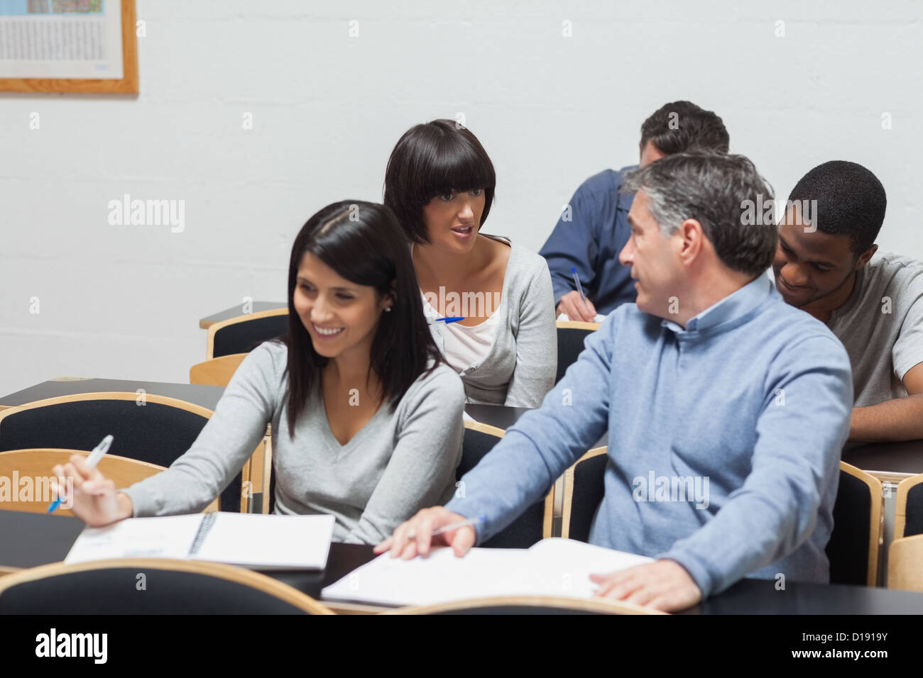 Students talking in lecture hall Stock Photo - Alamy