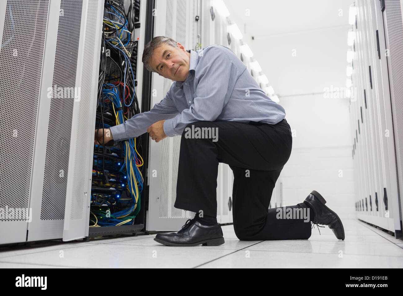Man fixing server wires Stock Photo - Alamy