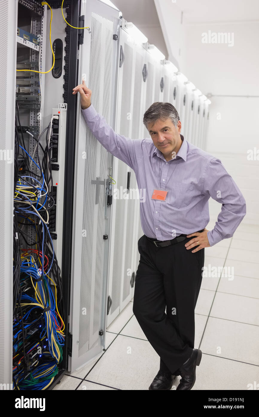 Man standing next to a server tower Stock Photo - Alamy