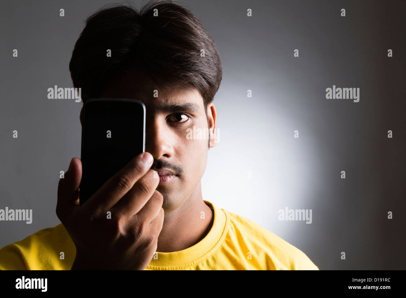 Portrait of a man holding a mobile phone Stock Photo - Alamy