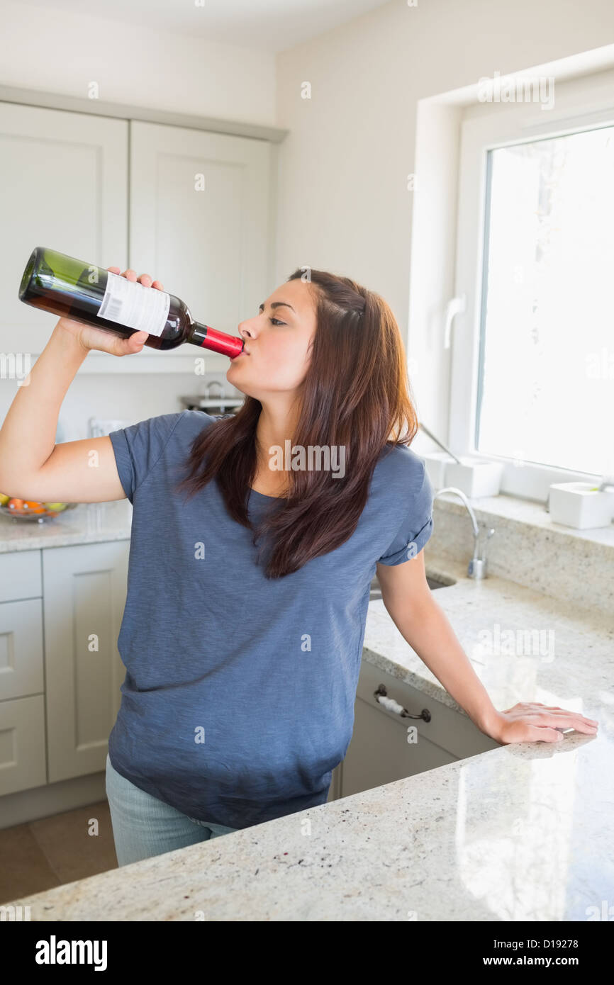 Woman drinking wine straight out of the bottle Stock Photo - Alamy