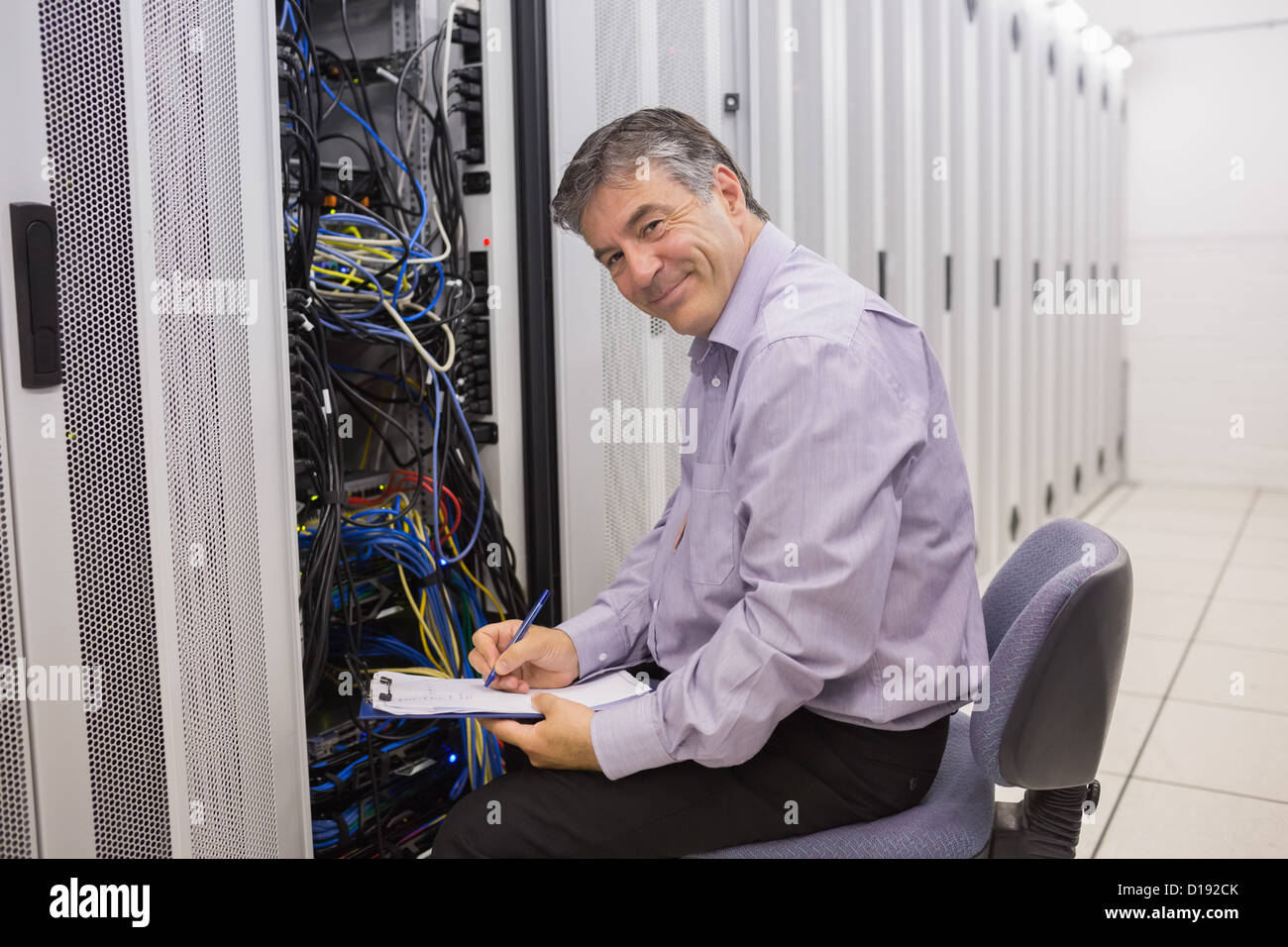Happy technician repairing the server Stock Photo - Alamy