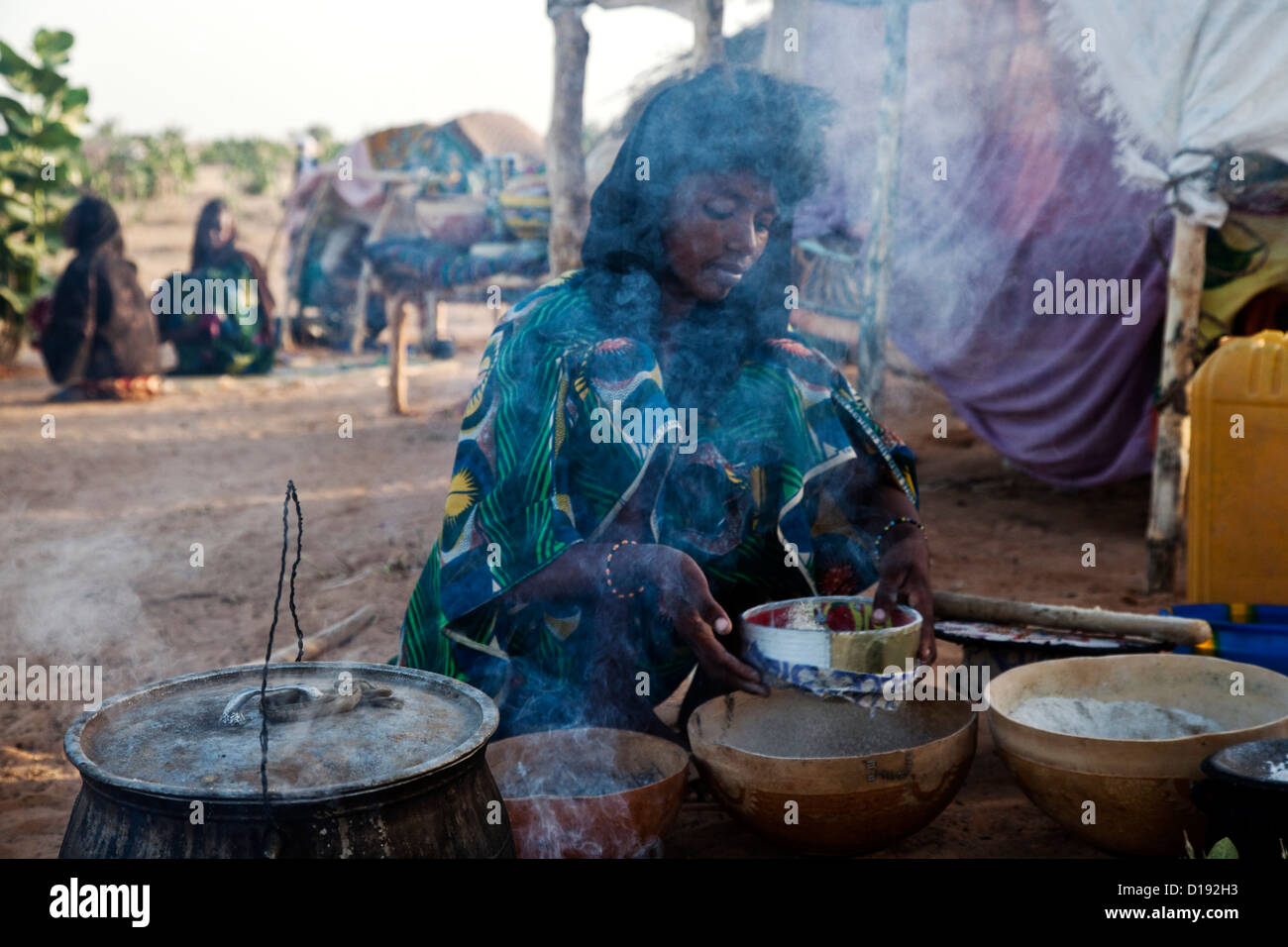 Wodaabe nomad woman cooking at the Wodaabe camp near Ingal, Niger ...