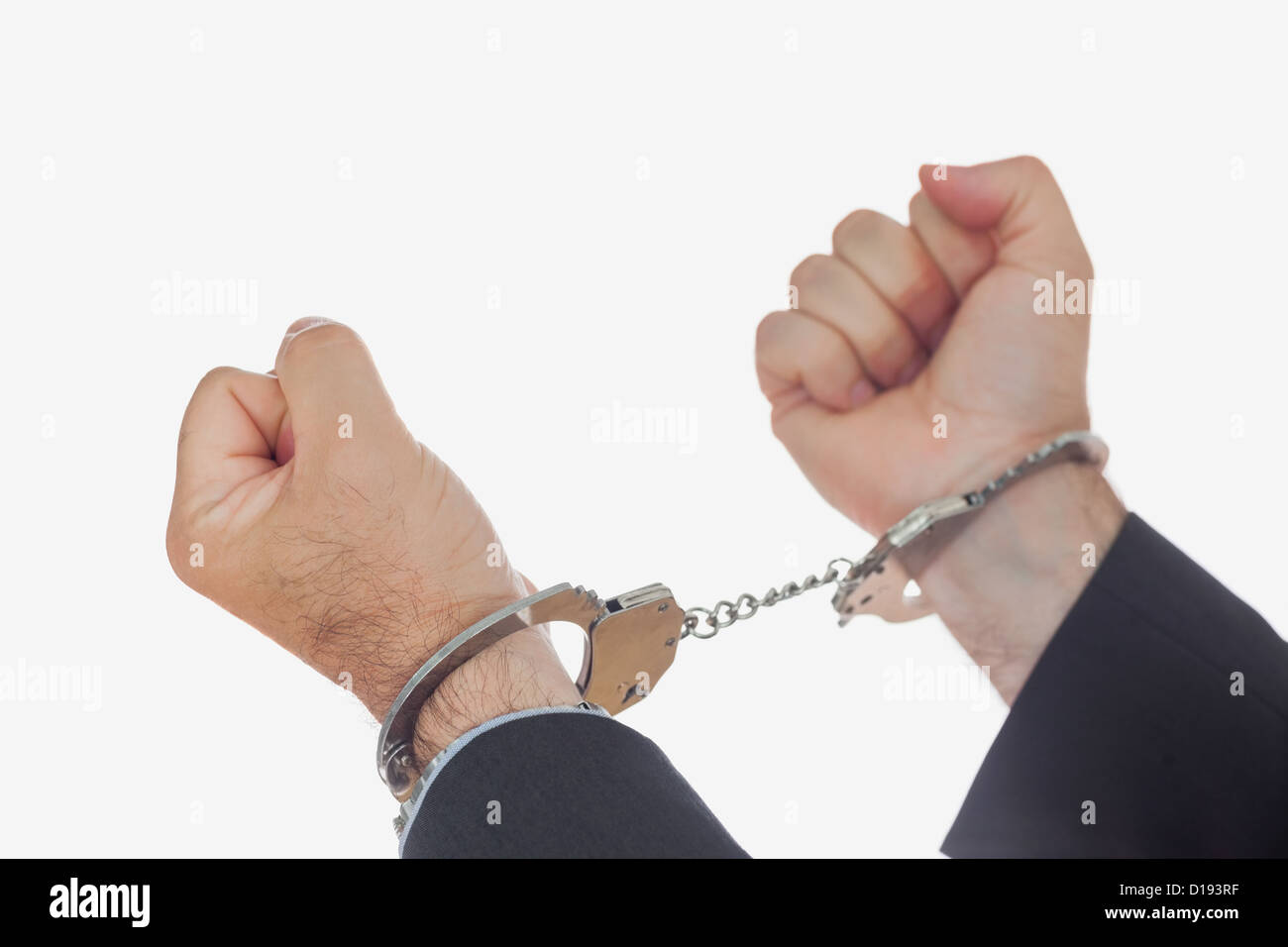 Man in handcuffs clenching fists Stock Photo - Alamy
