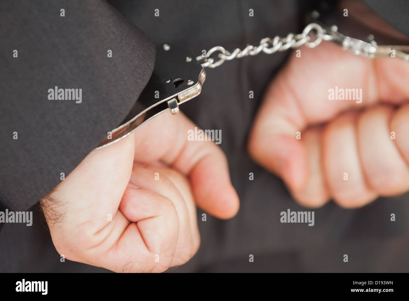 Hands in handcuffs clenching fists Stock Photo - Alamy