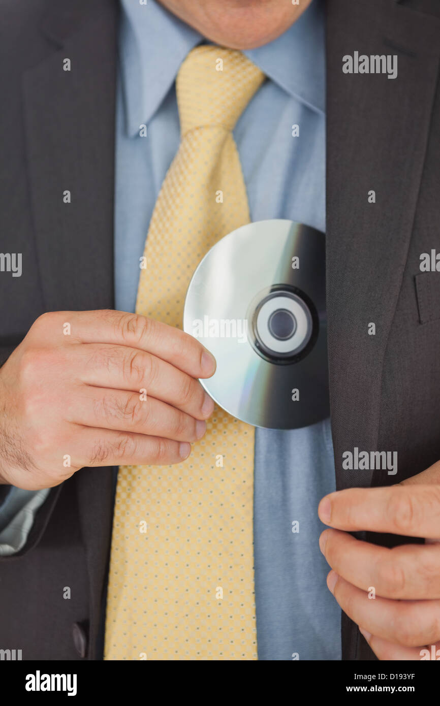 Businessman putting CD in his pocket Stock Photo - Alamy