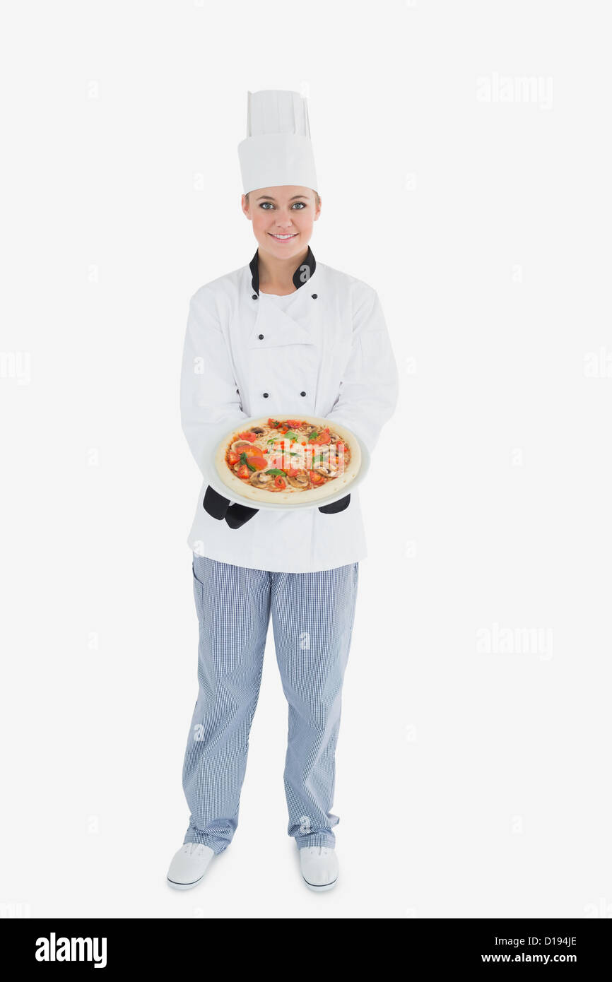 Female chef offering pizza Stock Photo - Alamy