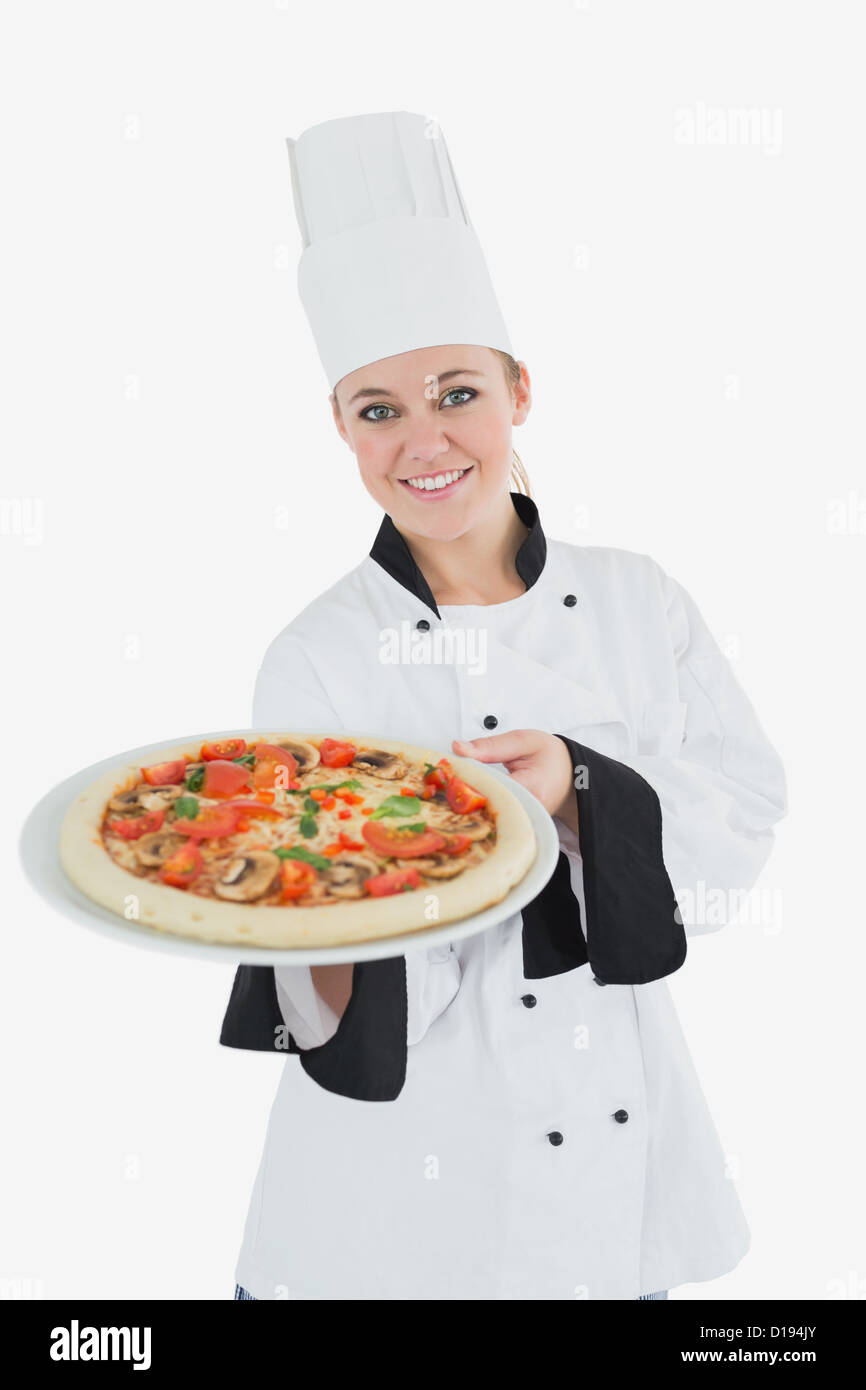 Happy female chef with pizza Stock Photo - Alamy