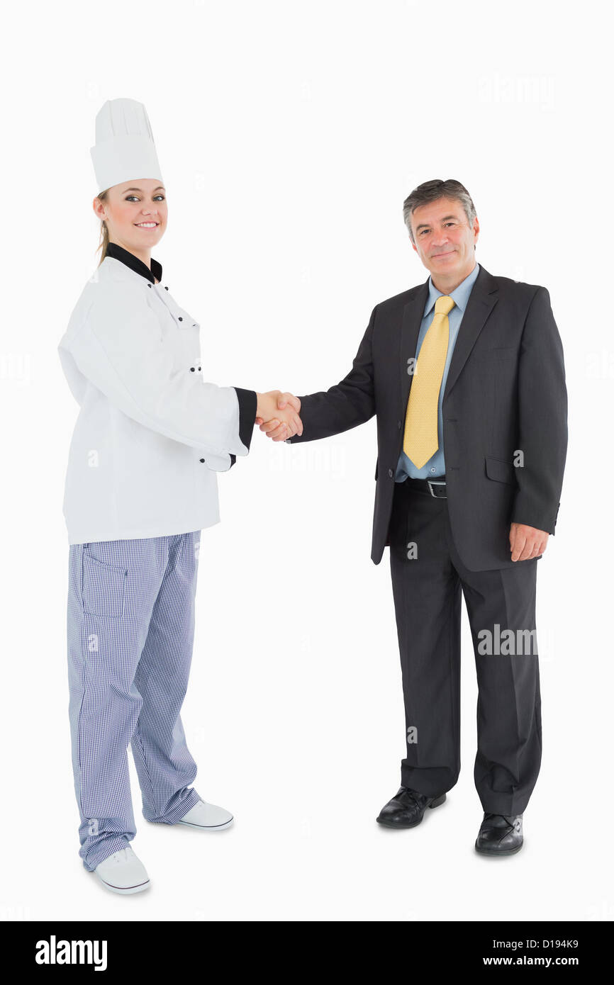 Portrait of businessman and female chef shaking hands Stock Photo - Alamy