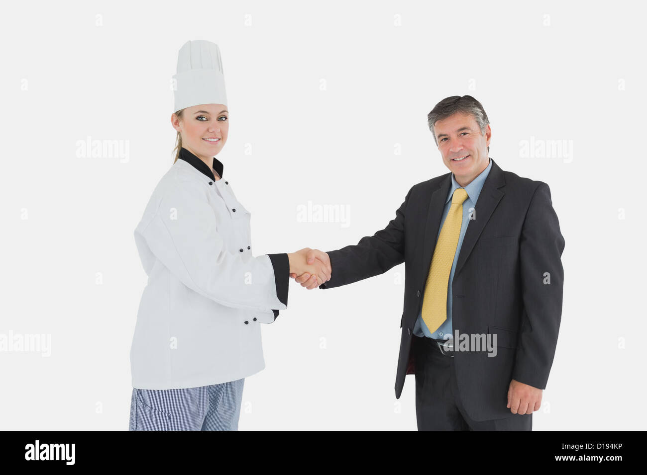 Happy businessman and female chef shaking hands Stock Photo - Alamy