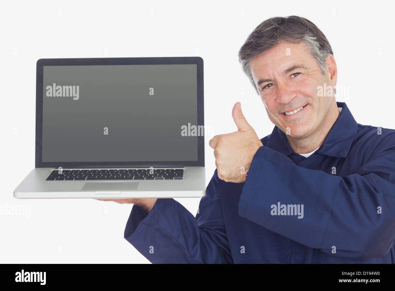 Mechanic with laptop showing thumbs up sign Stock Photo - Alamy