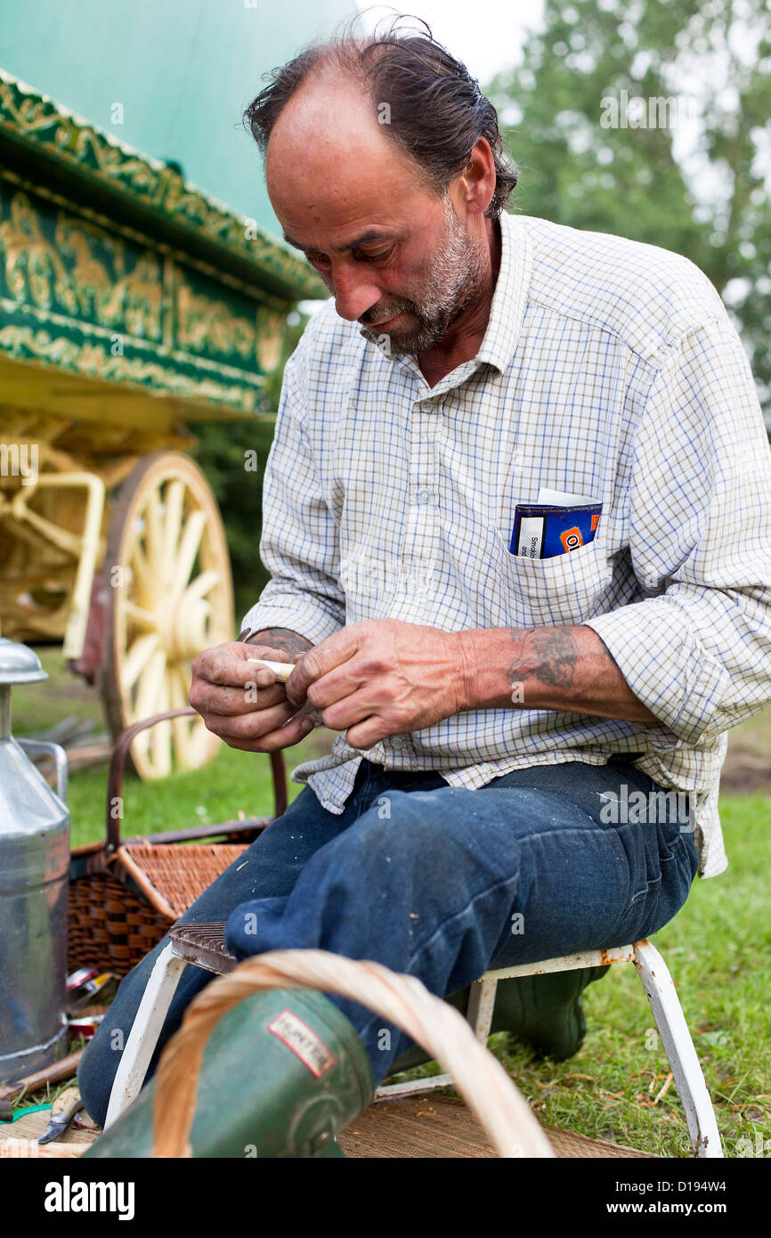 Romany gypsy making clothes pegs Stock Photo - Alamy