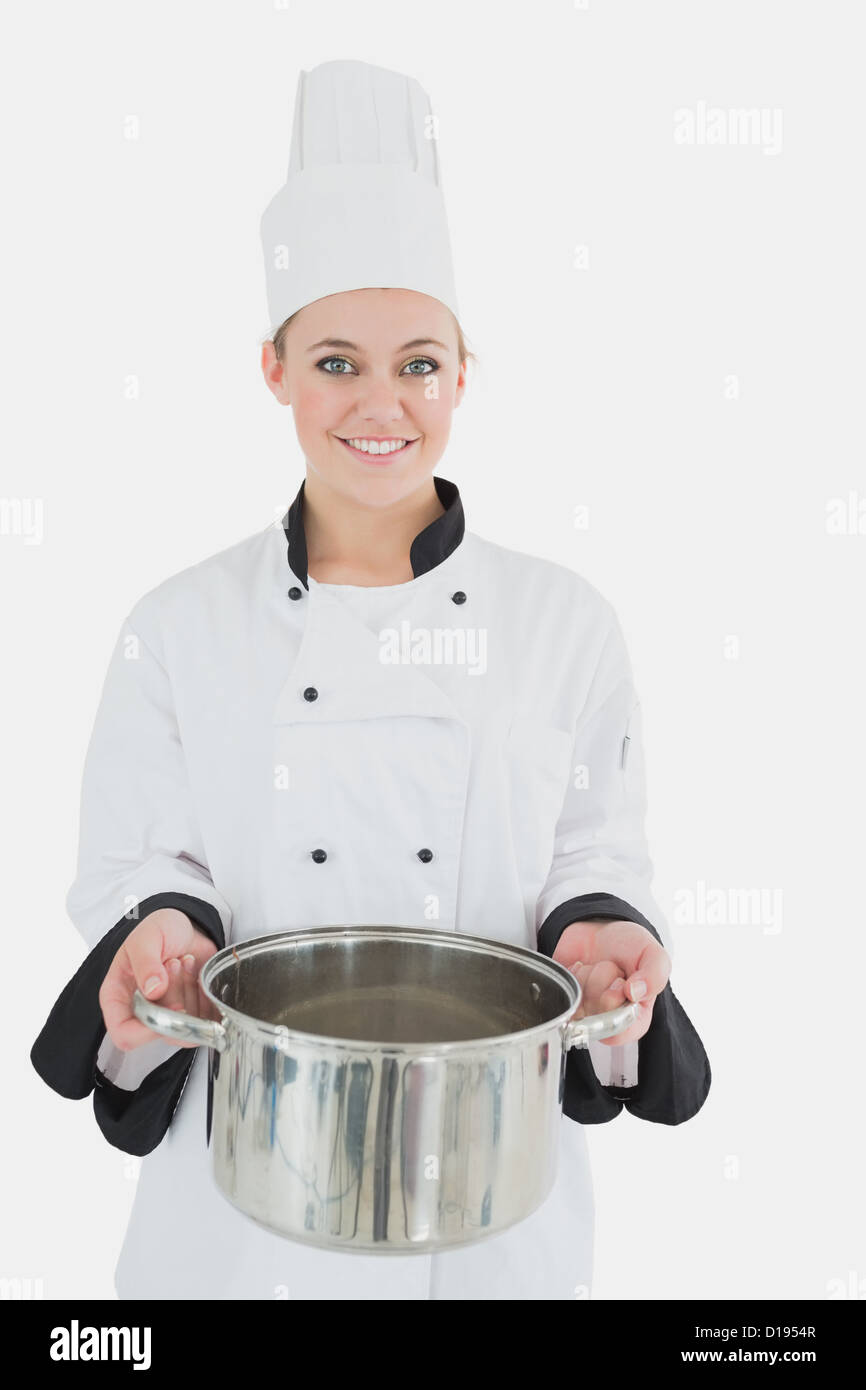 Happy female chef holding kitchen utensil Stock Photo - Alamy