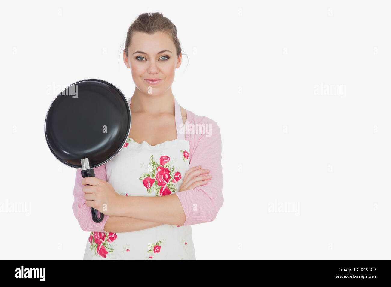 Portrait of woman in apron holding frying pan Stock Photo - Alamy