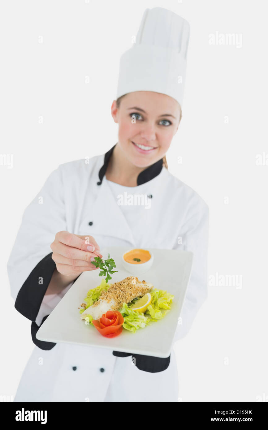 Female chef seasoning meal with parsley Stock Photo - Alamy