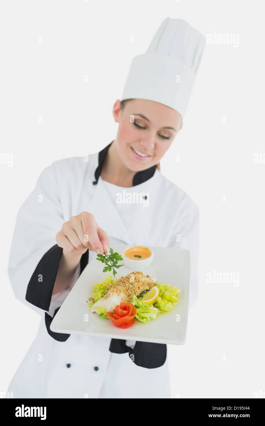 Chef seasoning dish with parsley Stock Photo - Alamy