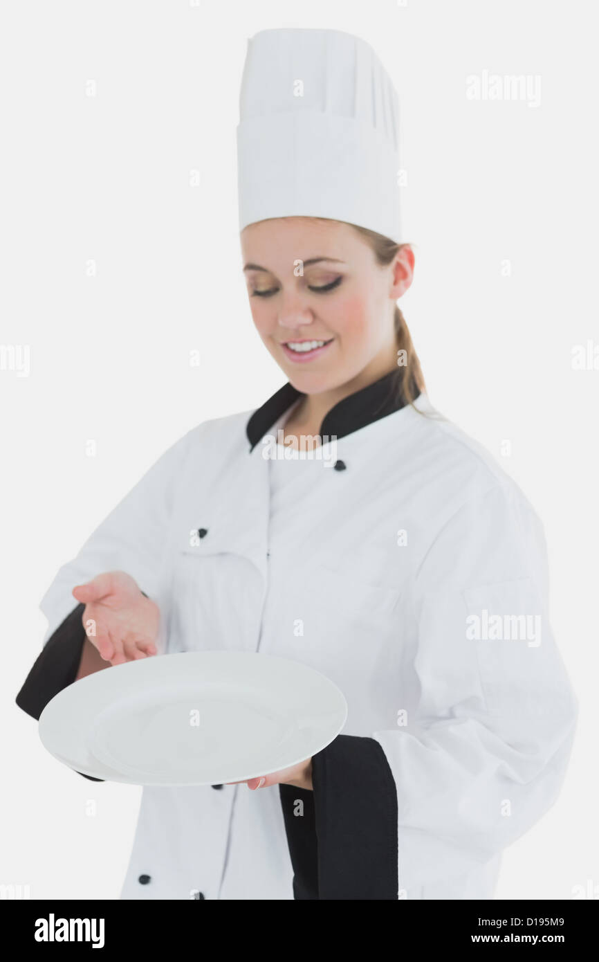 Chef in uniform with an empty plate Stock Photo - Alamy