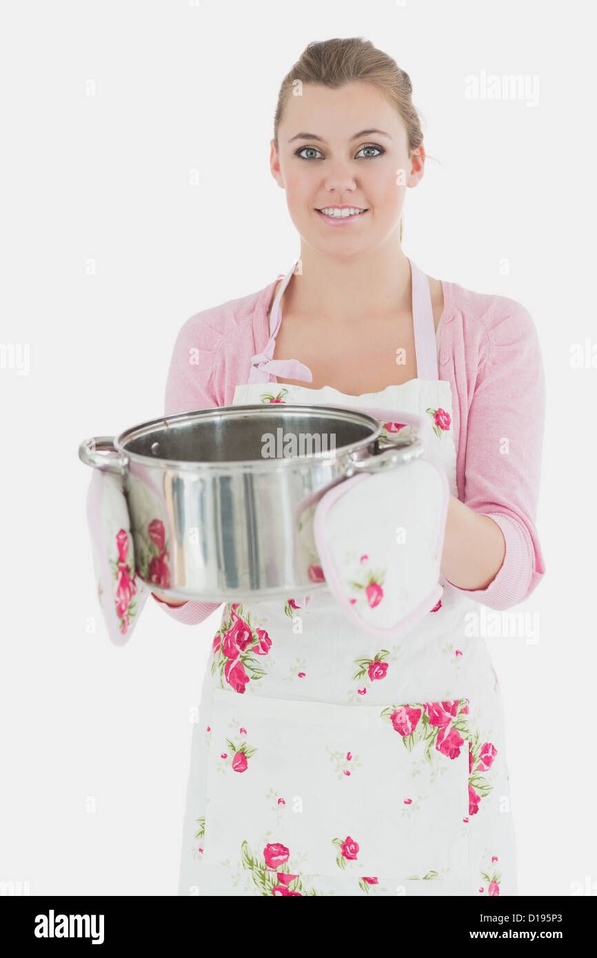 Portrait of young maid with cooking utensil Stock Photo - Alamy