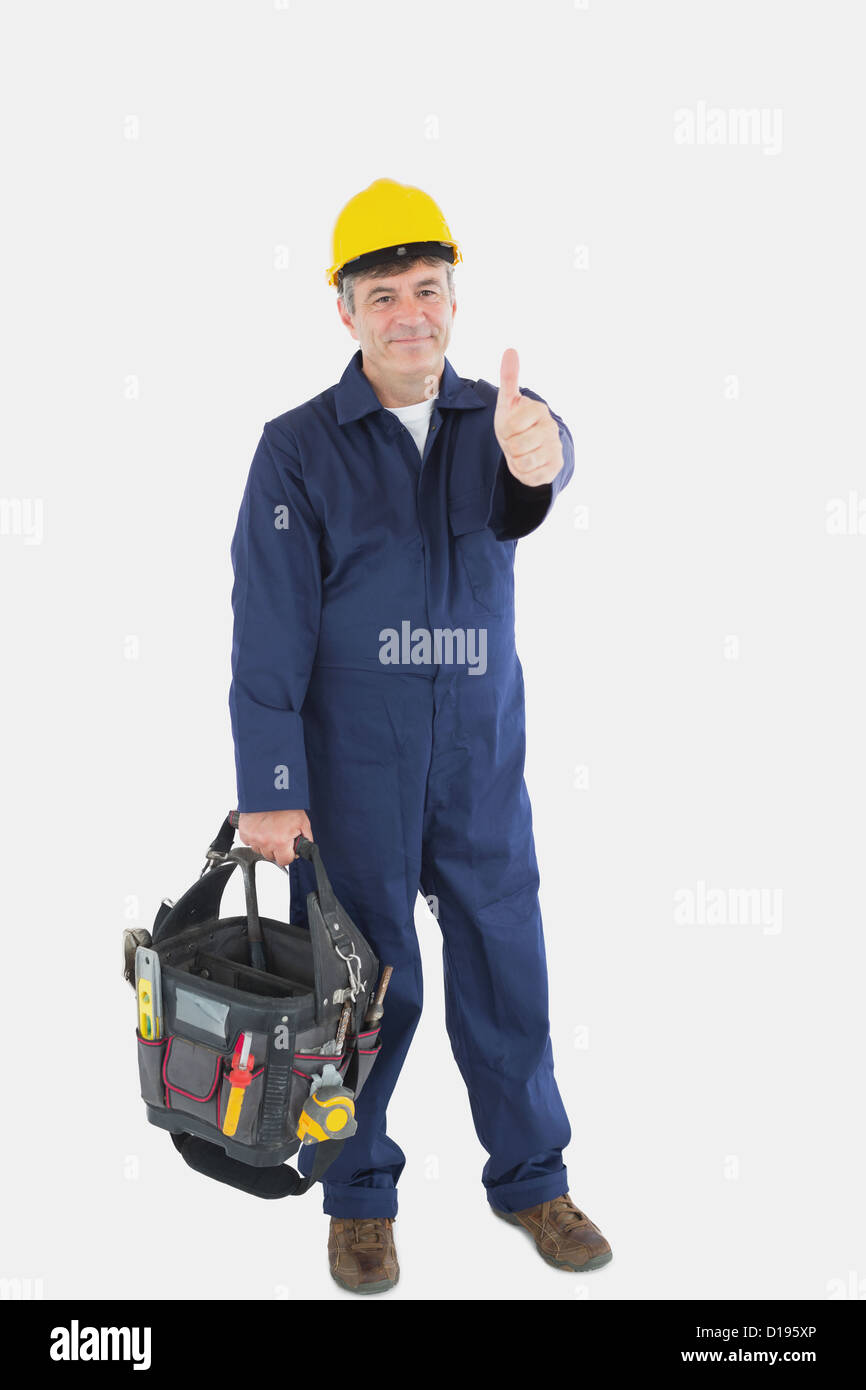 Mechanic with tool bag showing thumbs up sign Stock Photo - Alamy