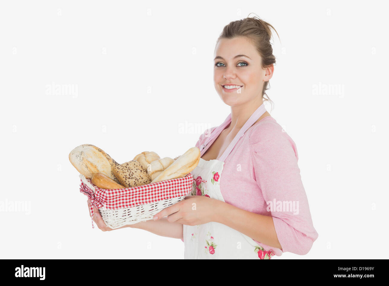 Young woman holding basket full of breads Stock Photo - Alamy