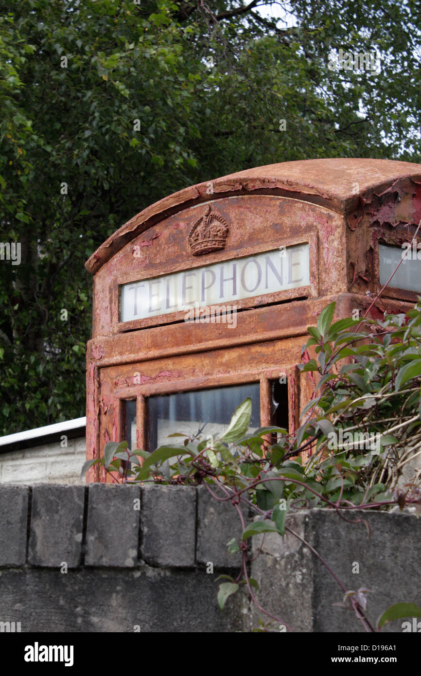 old red public telephone box in garden in wales, great britain, uk ...